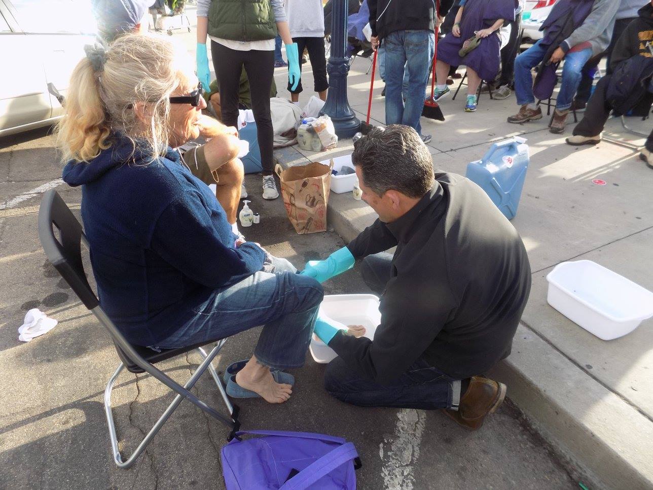 Washing the feet of a homeless women for Easter on the streets of San ...