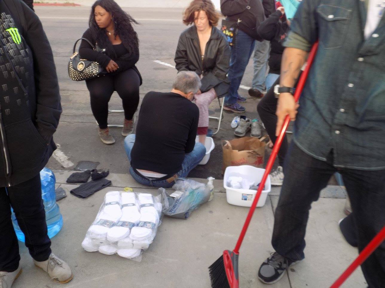 Washing the homeless' feet at our Easter event. - Streets Of Hope San Diego